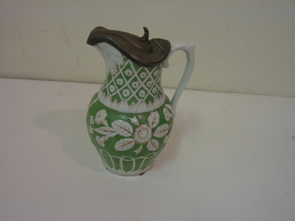 I just purchased a pitcher with a pewter (I believe) lid. The lid is ...